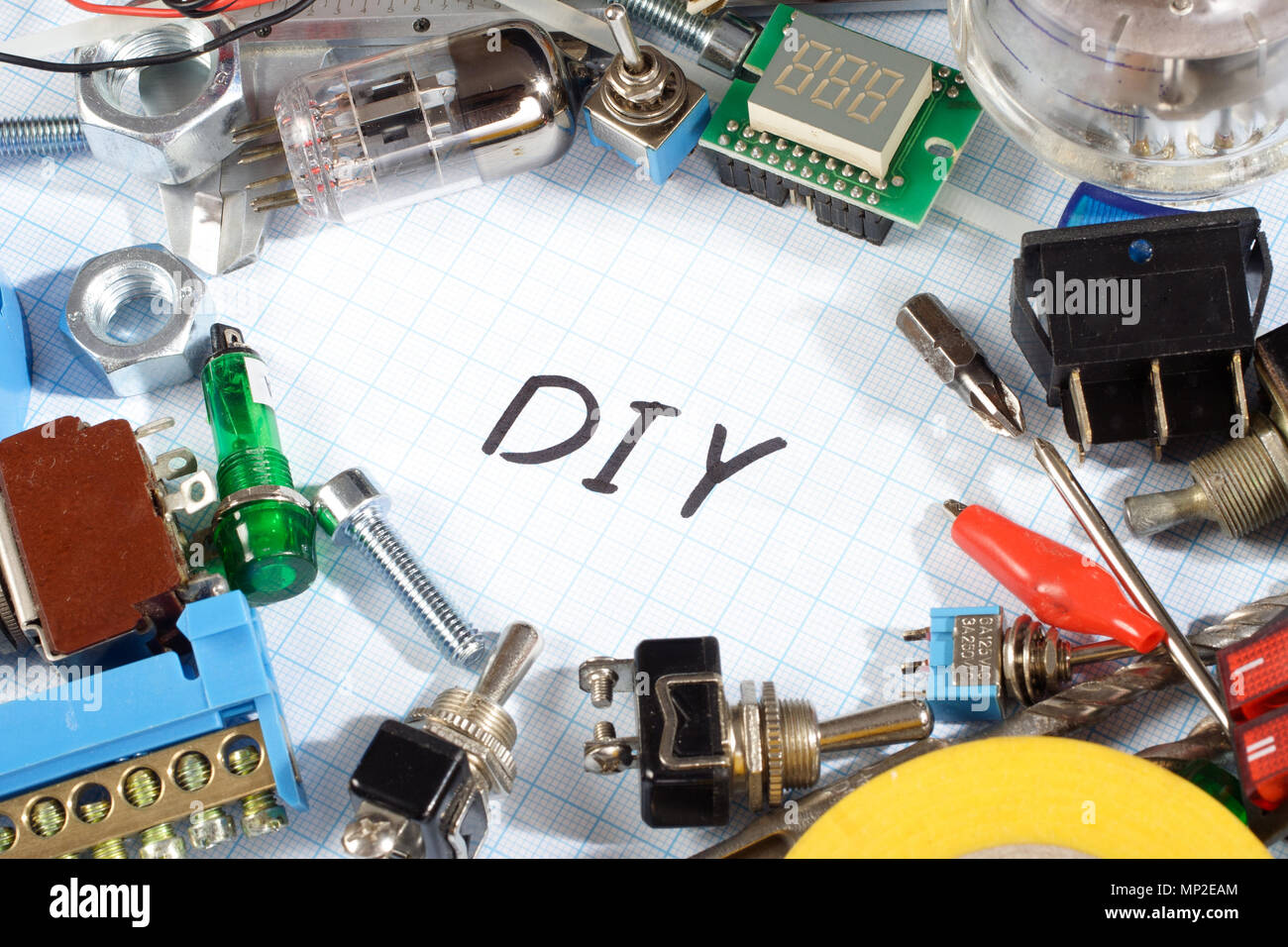 "Do it yourself" - radio-electronic parts on graph paper background ...