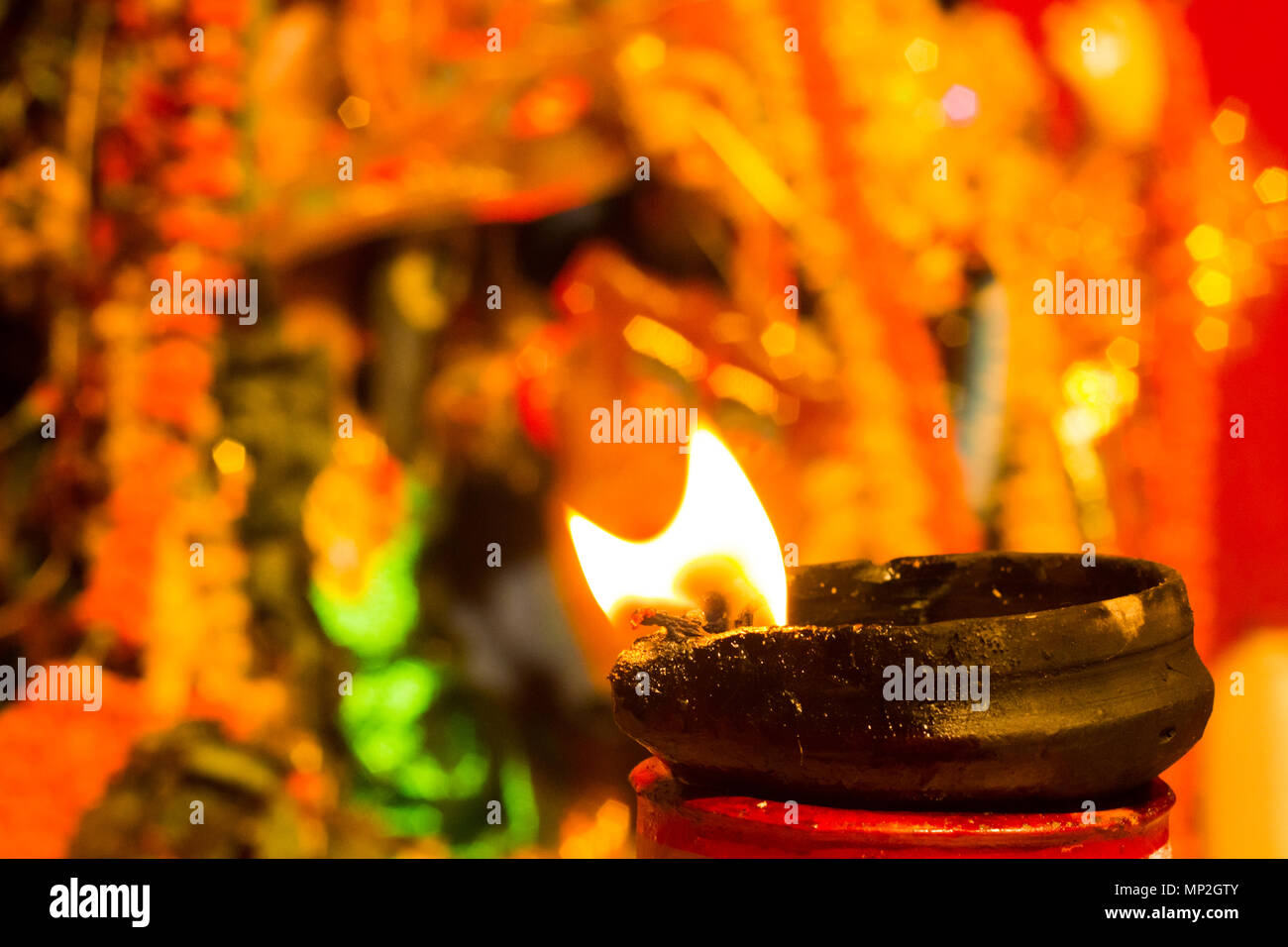 lit clay lamp on top of a clay stand or worship idol durgapuja india ...