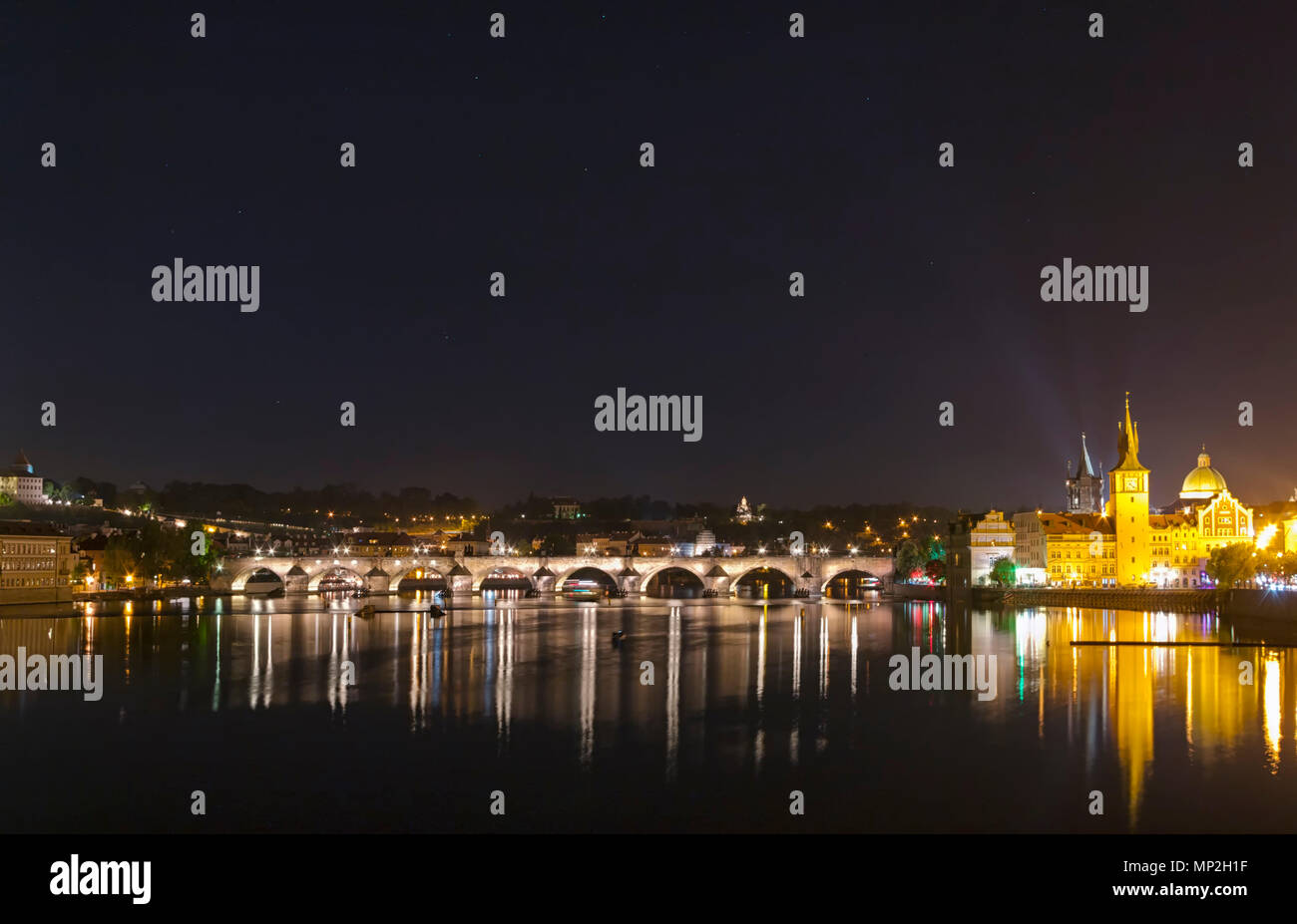 View of the famous Charles Bridge illuminated at night. Charles Bridge ...
