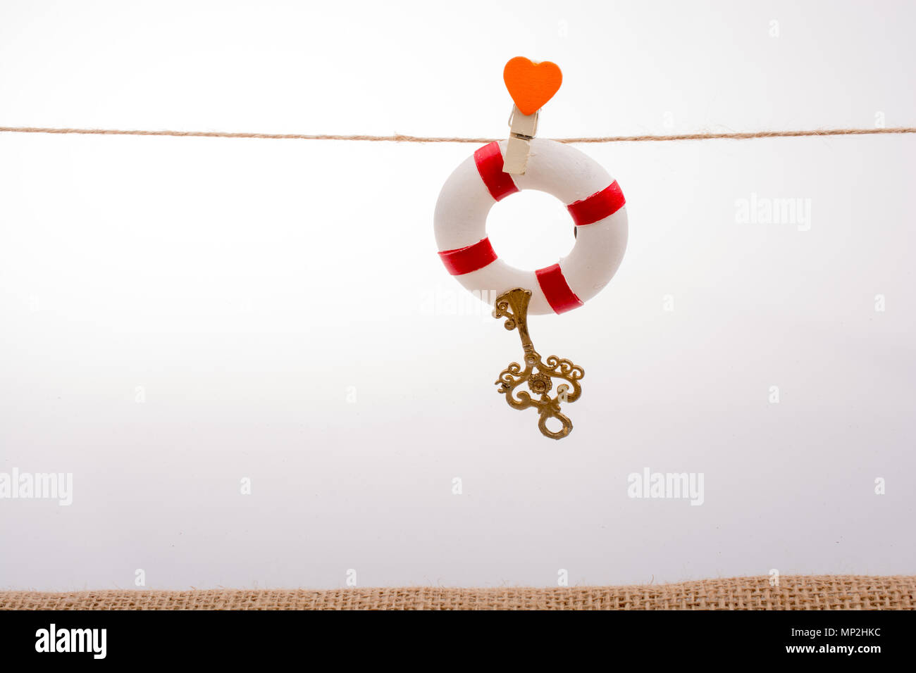 Life preserver attached to a string with heart icon Stock Photo - Alamy