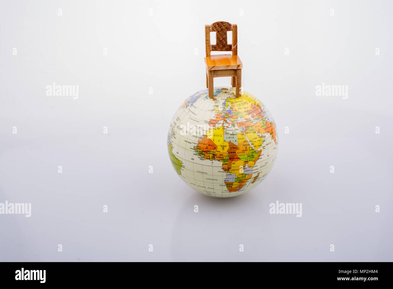 Chair is placed on the top of the model globe Stock Photo - Alamy