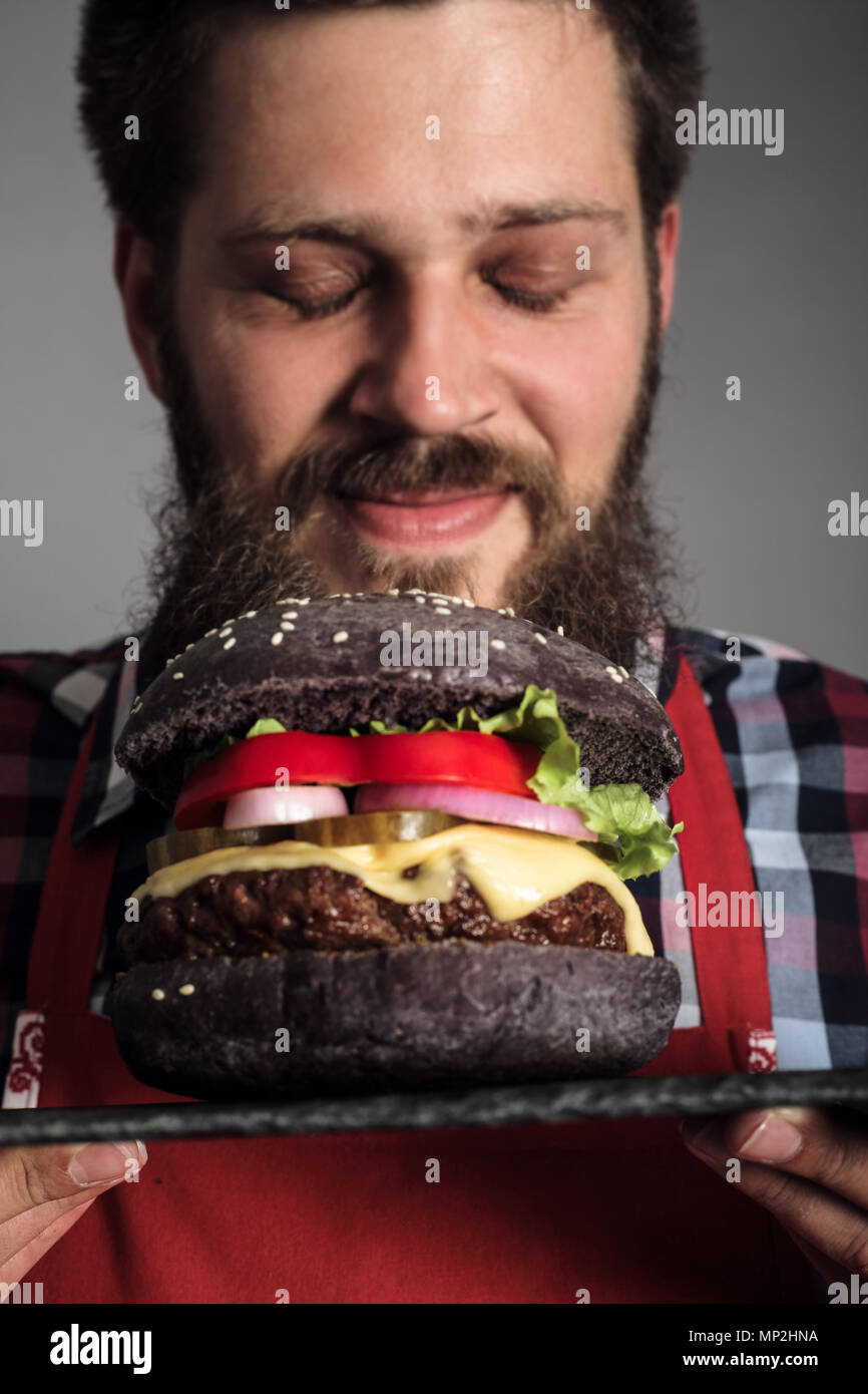 Man enjoy smelling fresh self made burger close up Stock Photo - Alamy