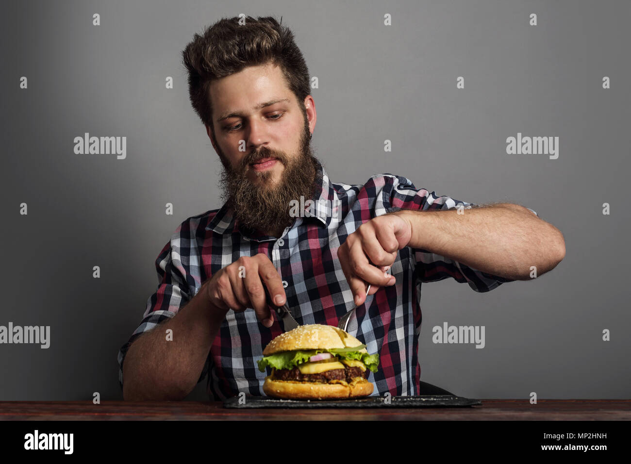 Man eating fresh self made burger close up Stock Photo - Alamy