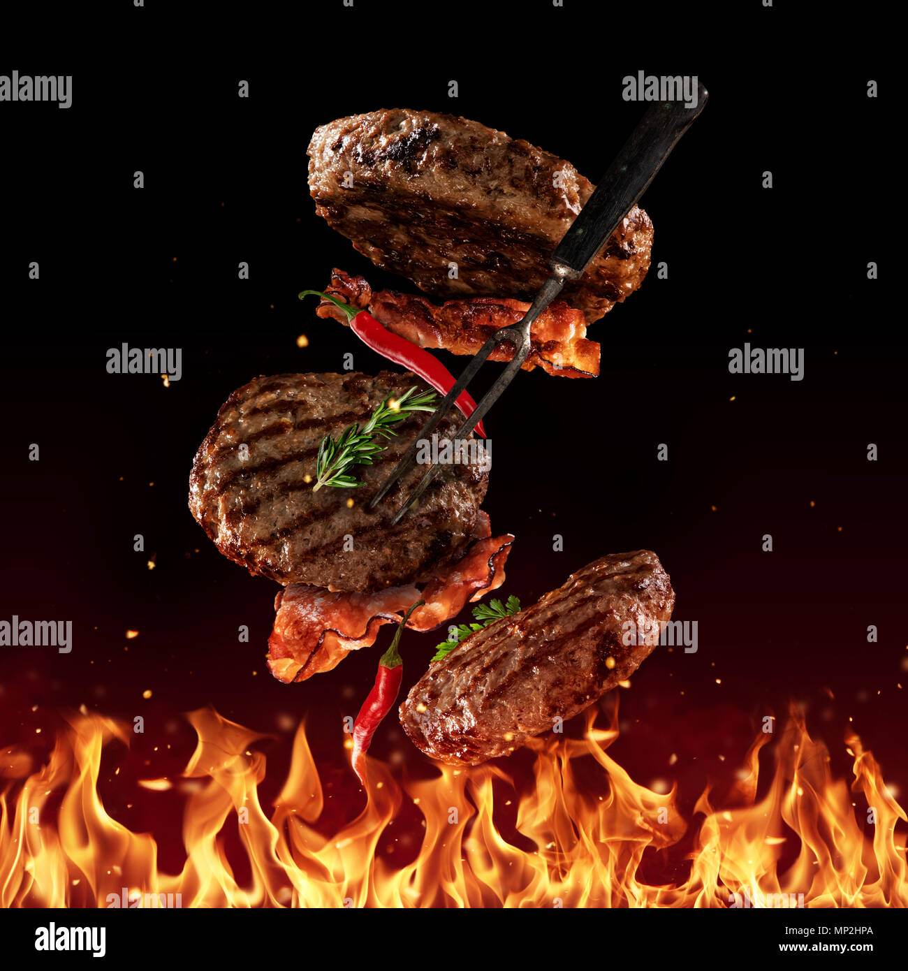 Flying beef minced hamburger pieces above grill flames, isolated on ...