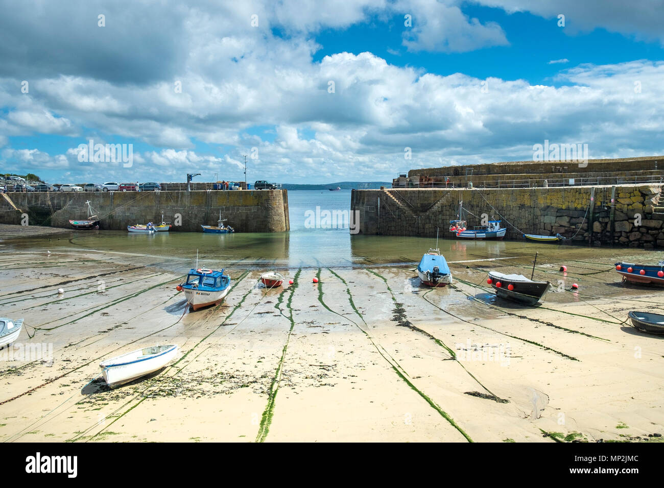 Low tide in Mousehole Harbour in Cornwall Stock Photo - Alamy
