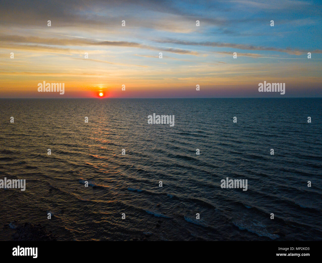 Beautiful sunset at sea side with stones Stock Photo - Alamy