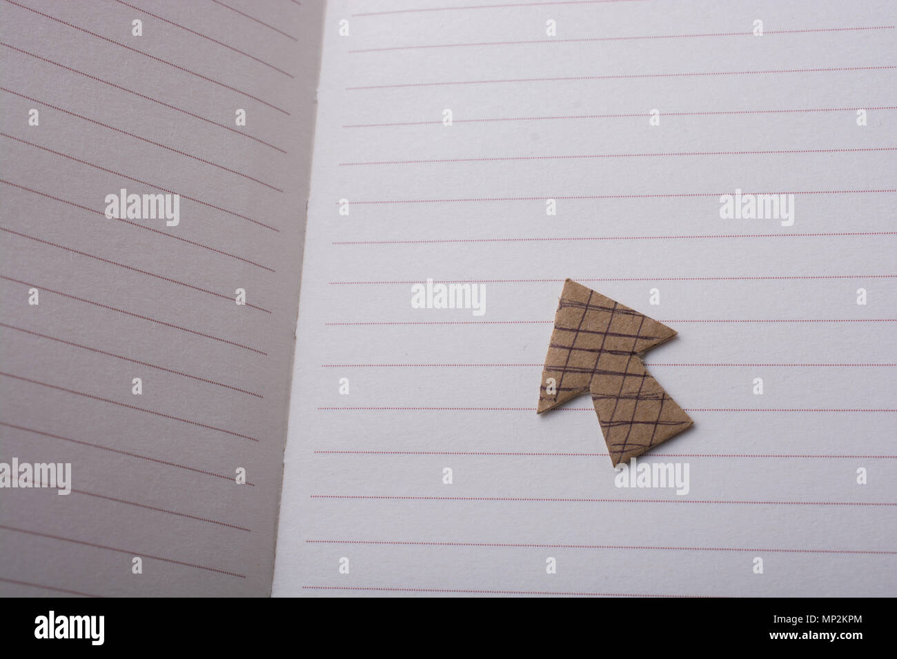 Arrow sign cut out of paper placed on paper on paper Stock Photo - Alamy