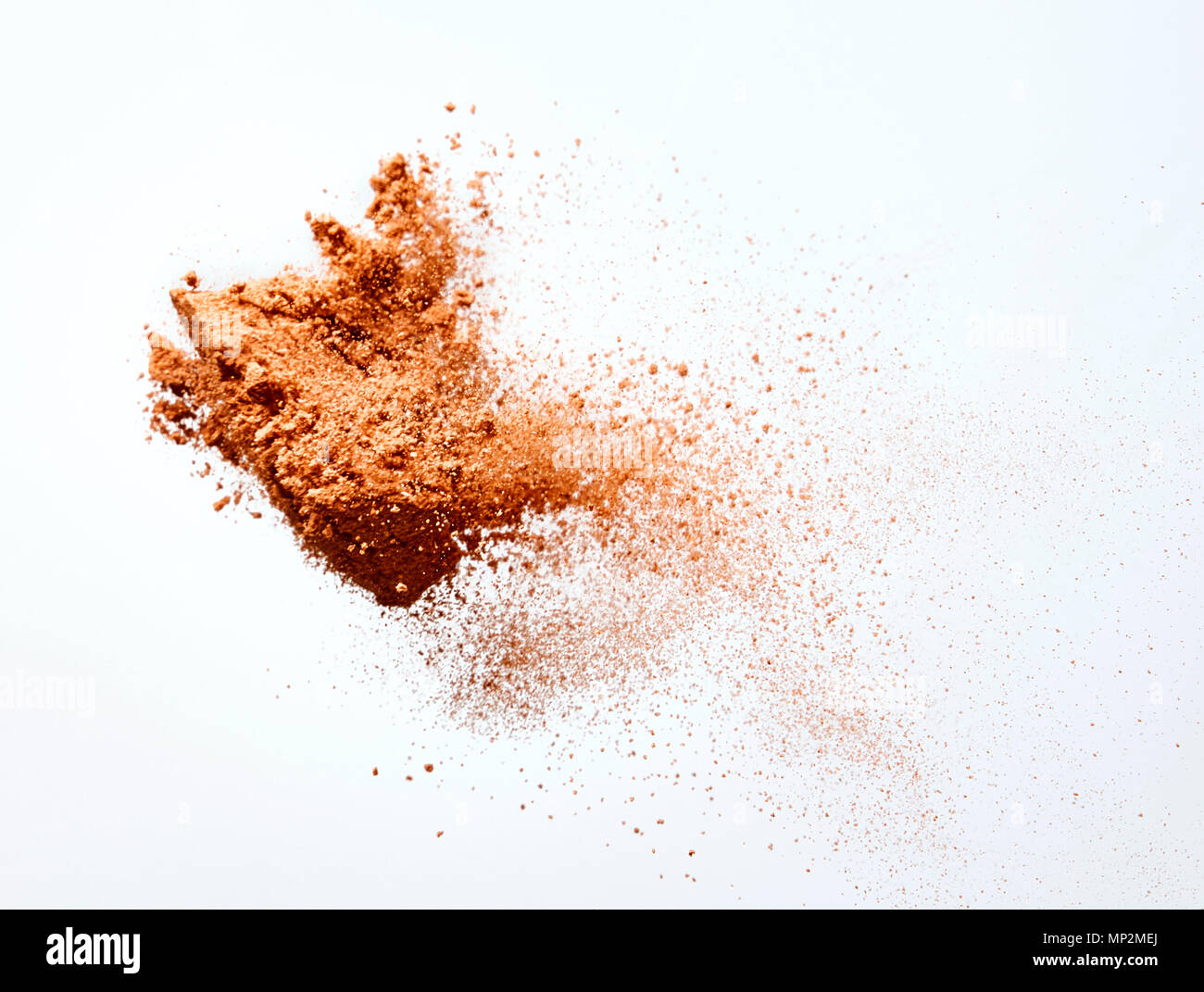 chocolate powder flying on white background Stock Photo - Alamy