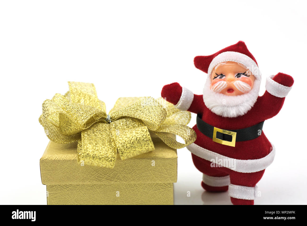 Santa claus doll and gift box isolated on white background Stock Photo ...