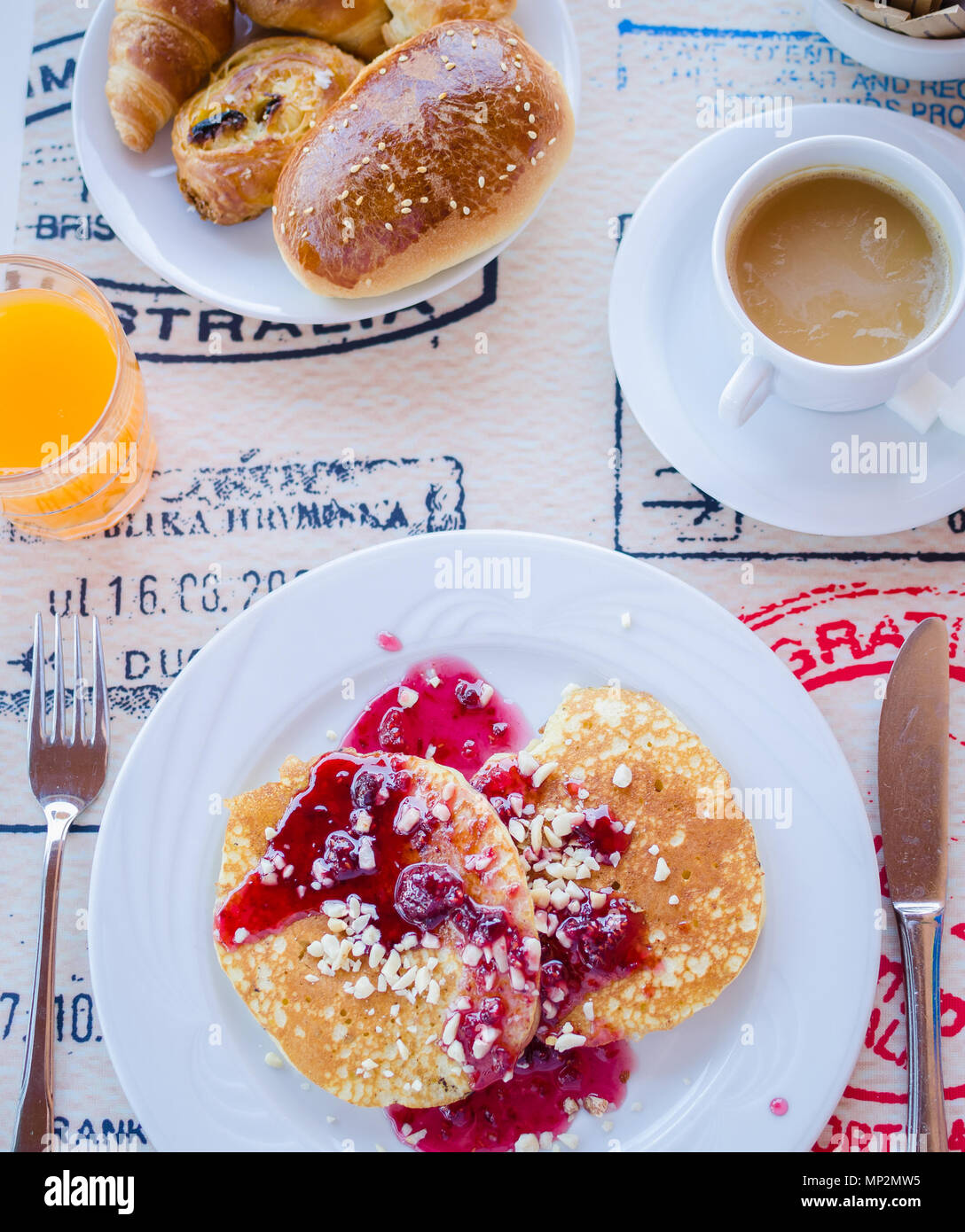 Breakfast including classic pancakes with raspberry jam, coffee with ...