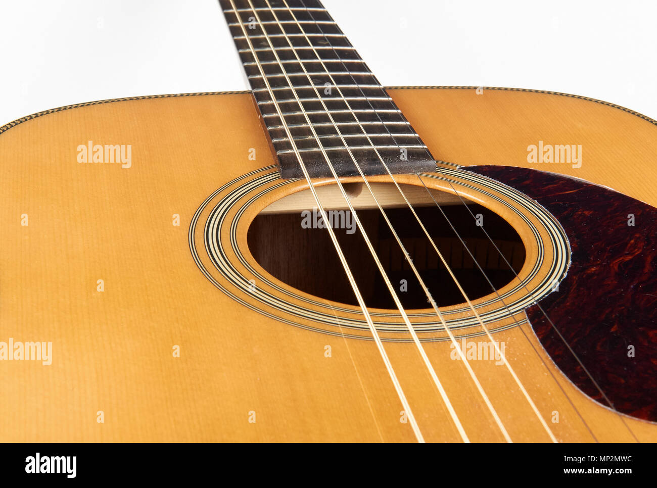 a detail of an acoustic guitar in white background Stock Photo - Alamy