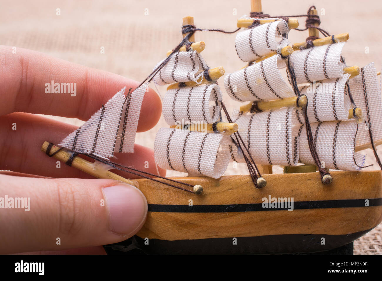 Hand made sail boat in hand on canvas Stock Photo - Alamy