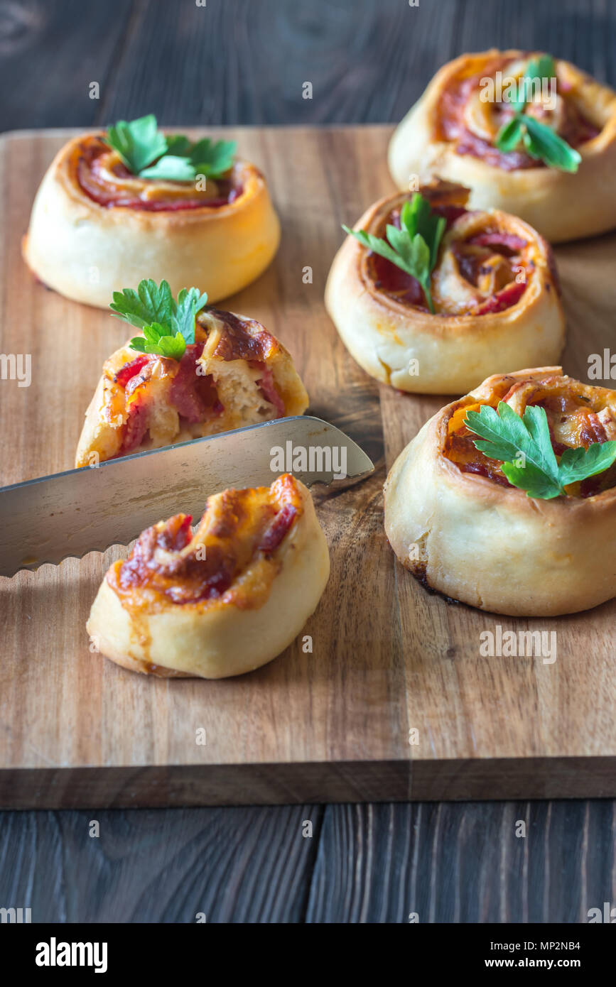Pizza rolls on the wooden board Stock Photo - Alamy