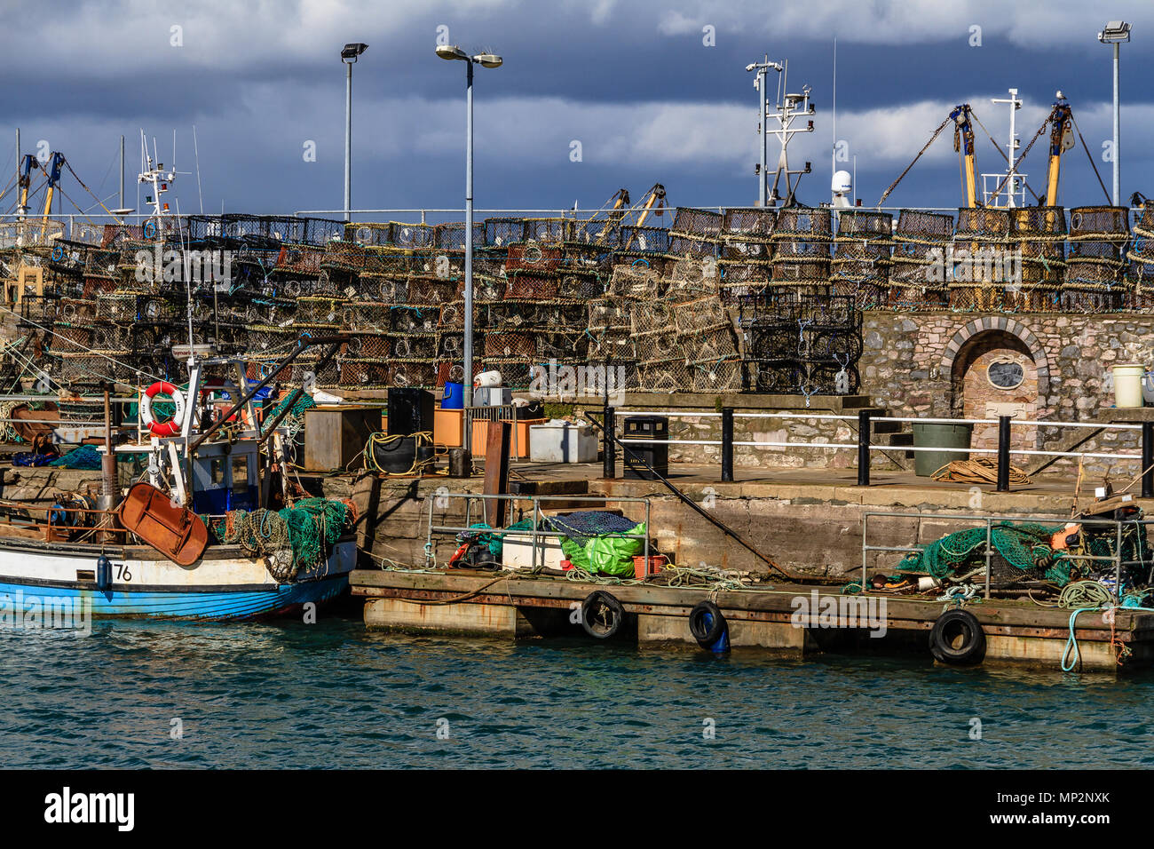 Lobster pots piled up beside the harbour at Brixham, Devon, UK. 2018 ...