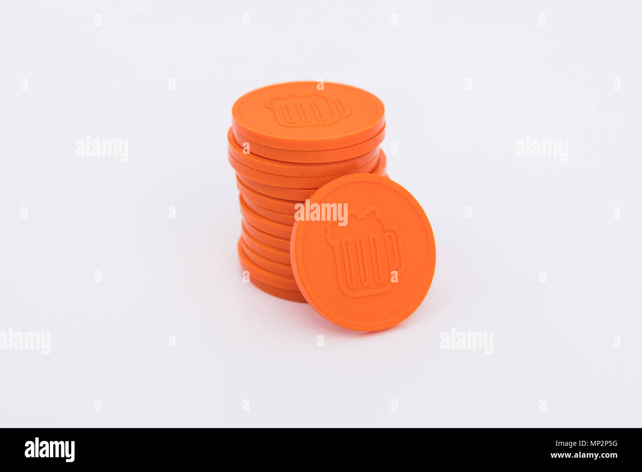 Pile of orange plastic beer tokens Stock Photo - Alamy