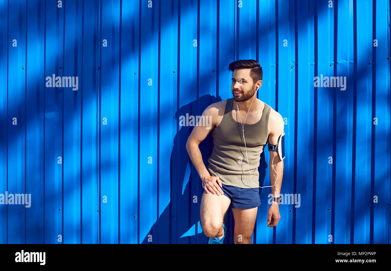 A man with a beard athlete runner in headphones Stock Photo - Alamy