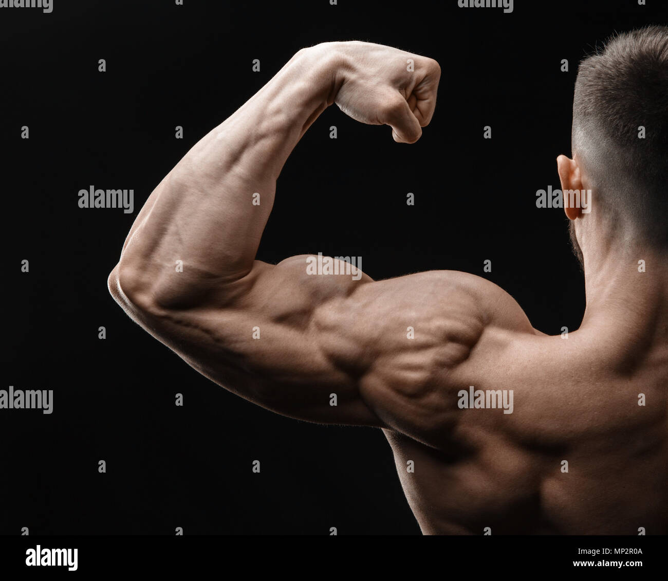 Bodybuilder in good shape against a dark background Stock Photo - Alamy
