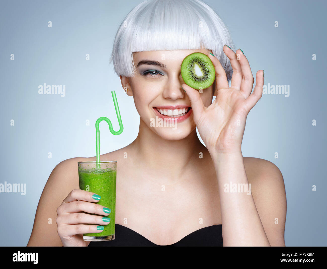 Smiling young girl holding smoothie detox cocktail of kiwi fruit. Photo ...