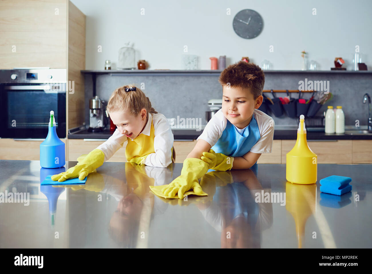 Smiling children do the cleaning in the kitchen Stock Photo - Alamy