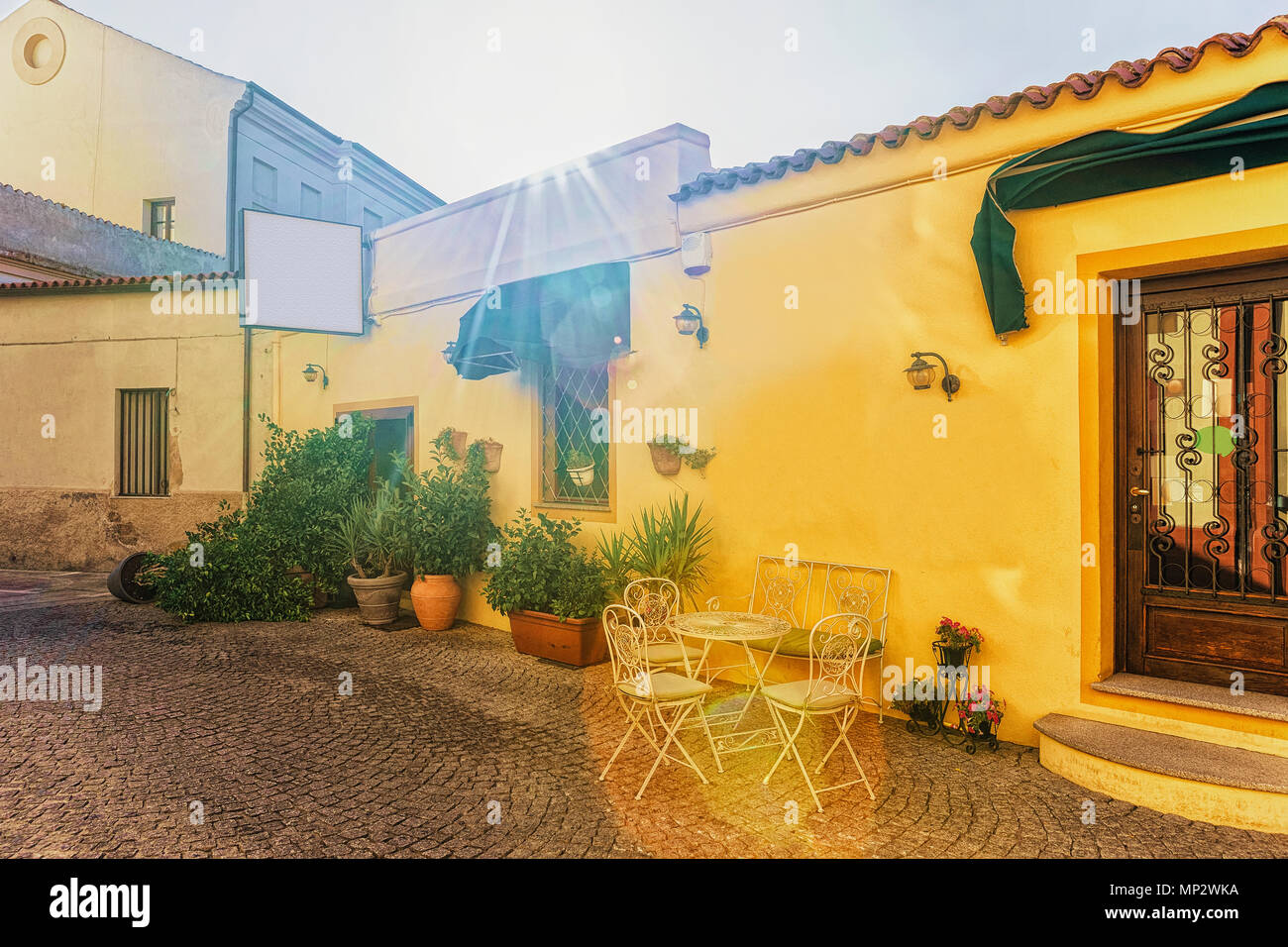Cozy sidewalk cafe with flower pots in Olbia, Sardinia, Italy Stock ...
