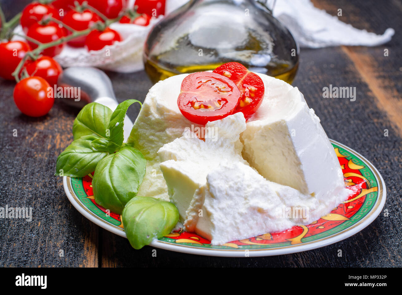 Italian soft cheese, young white ricotta cheese served with fresh basil ...
