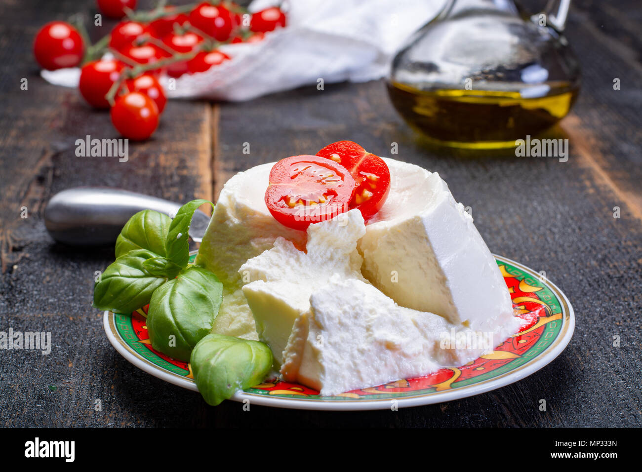 Italian soft cheese, young white ricotta cheese served with fresh basil ...