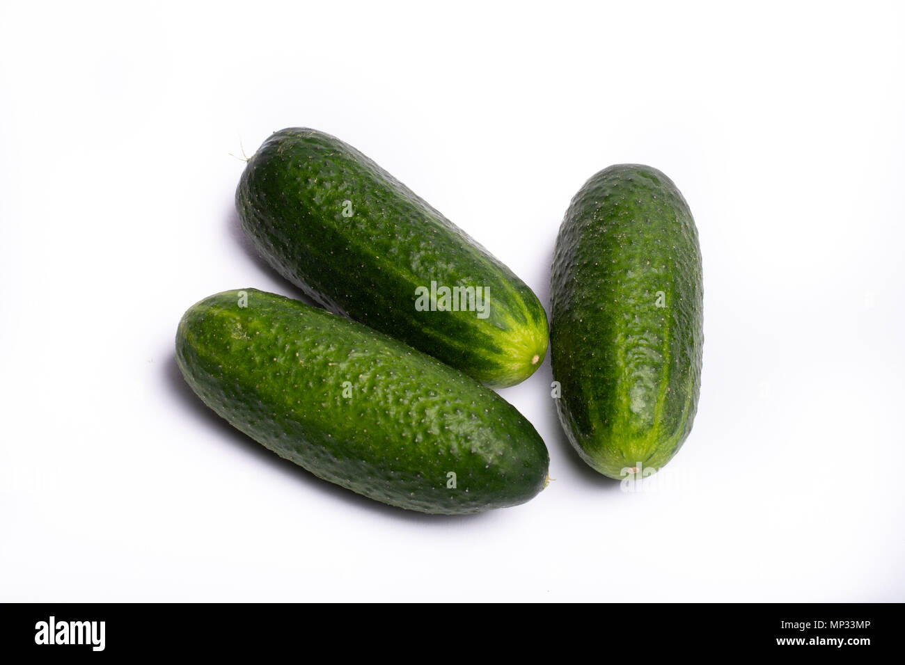 Fresh small green cucumbers close up copy space isolated on white ...