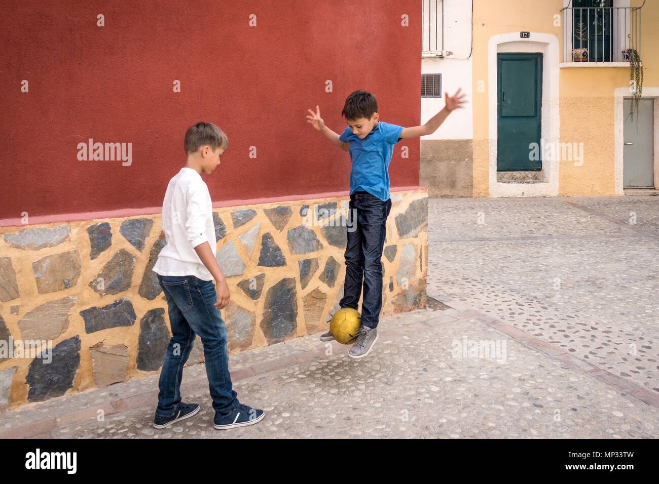 Two boys playing football city hi-res stock photography and images - Alamy