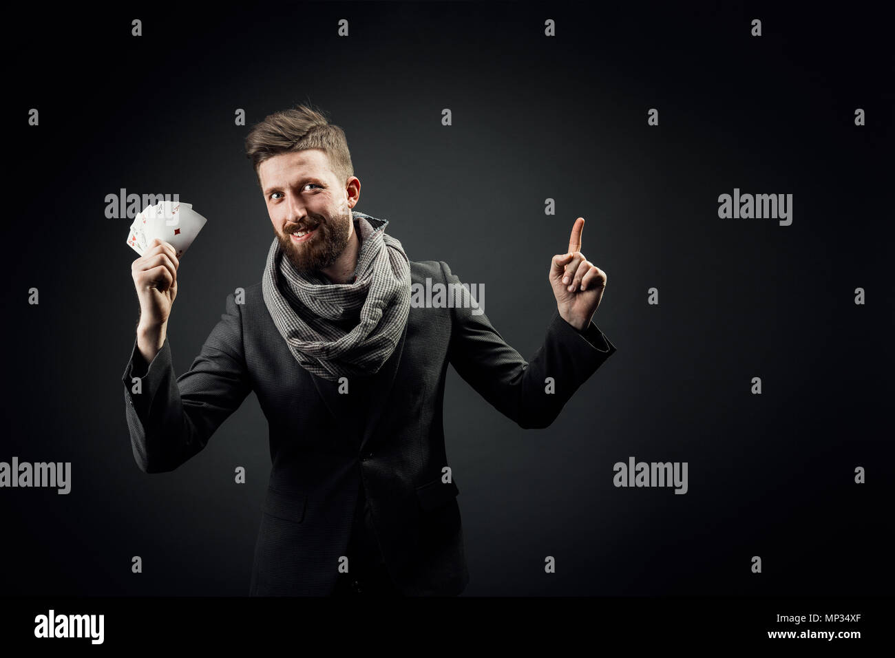 Man with playing cards on a dark background Stock Photo - Alamy