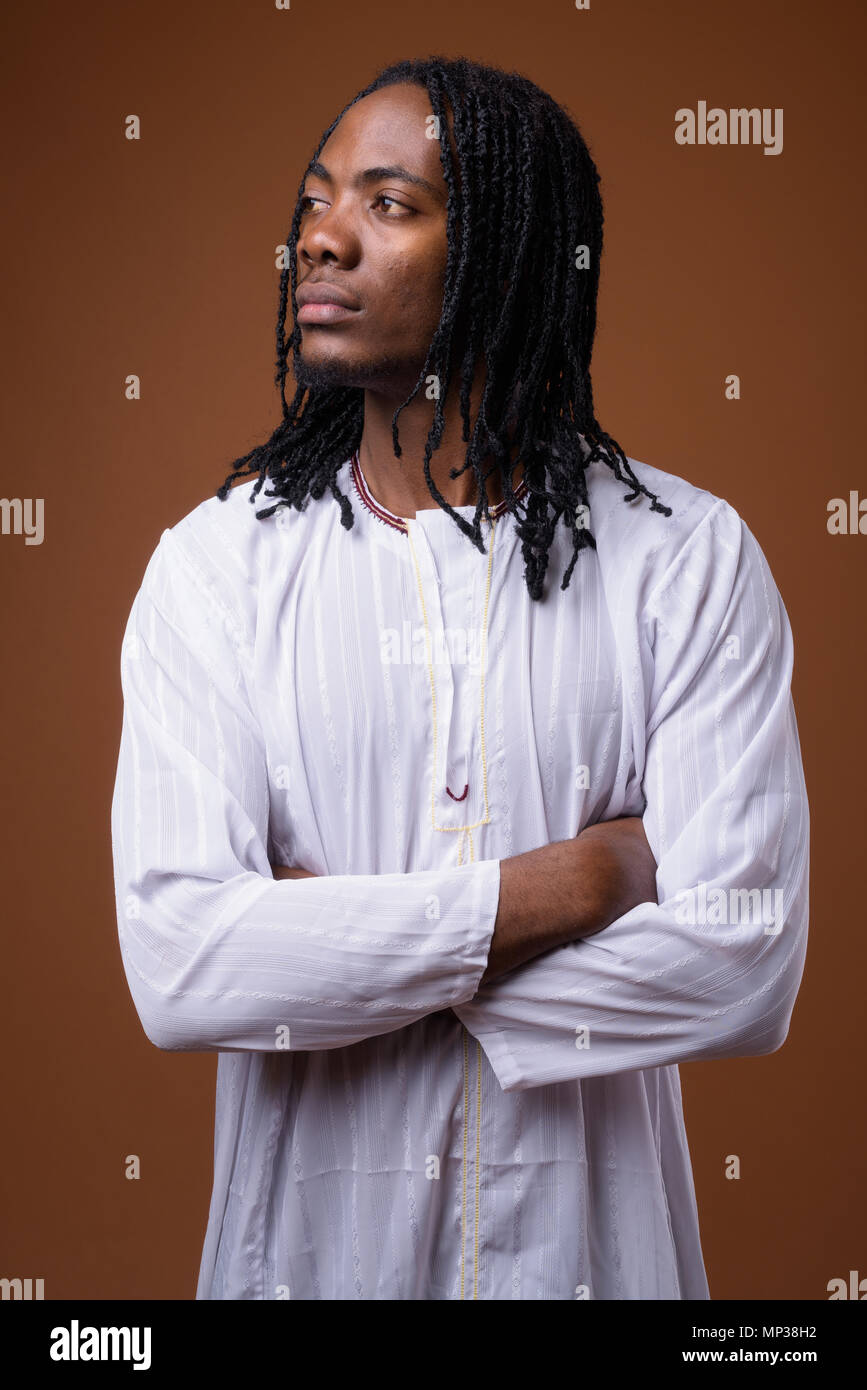 Young handsome African man wearing traditional clothes Stock Photo - Alamy