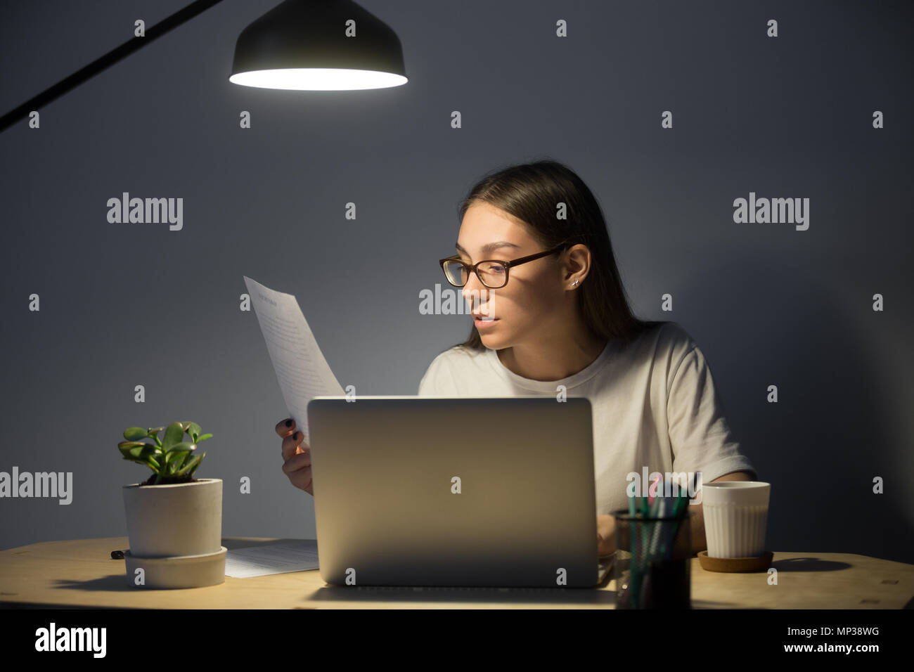 Serious student reading handouts getting ready for exam Stock Photo - Alamy
