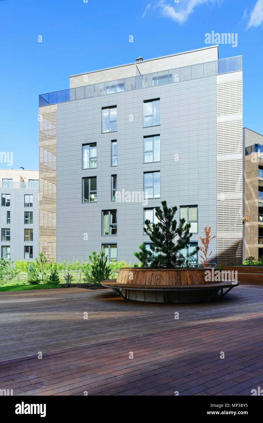 Pine tree at architectural complex of apartment residential buildings ...