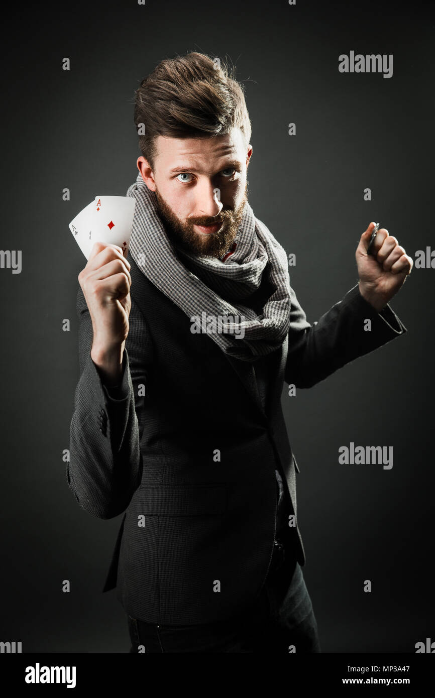 Man with playing cards on a dark background Stock Photo - Alamy