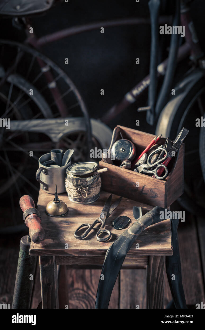 Retro bicycle repair workshop with tools, wheels and tube Stock Photo ...
