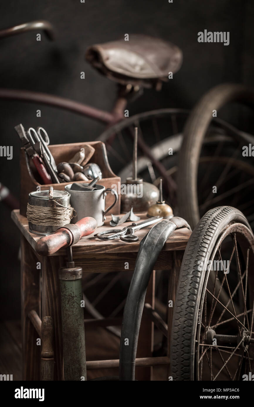 Retro bicycle repair workshop with wheels, tools, and rubber patch ...