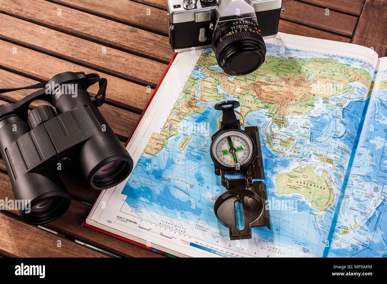 Travel planning. Top view of binoculars, compass, photocamera and map on a wooden table Stock ...