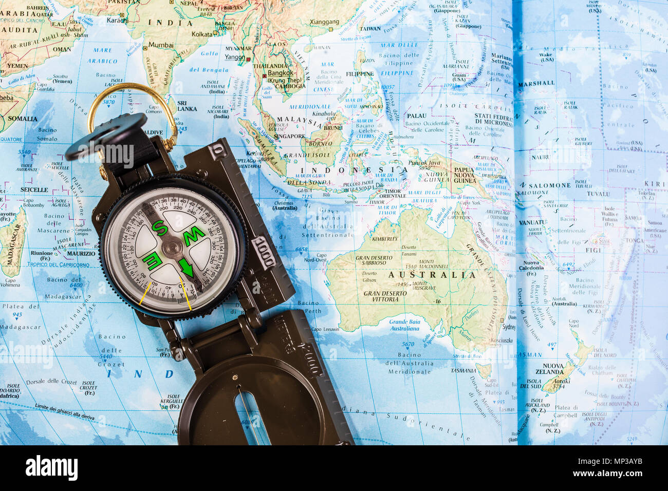 Travel planning. Close up of compass on map Stock Photo - Alamy