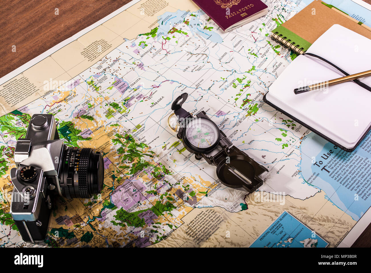 Travel planning. Compass, passport, photo camera and block notes on map ...