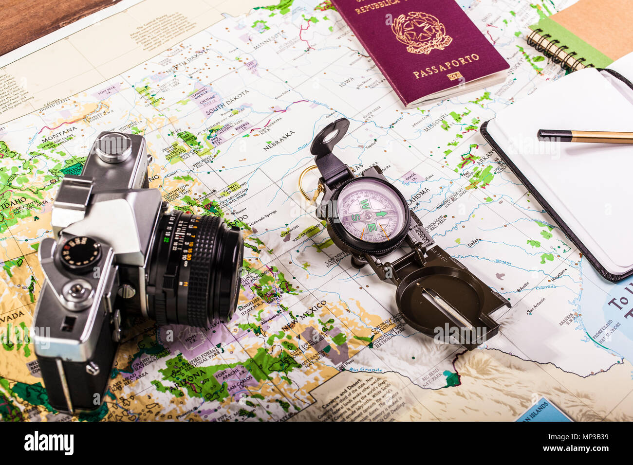 Travel planning. Compass, passport, photo camera and block notes on map ...
