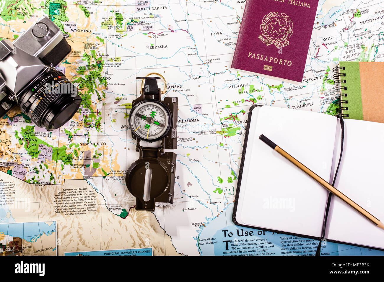 Travel planning. Compass, passport, photo camera and block notes on map ...