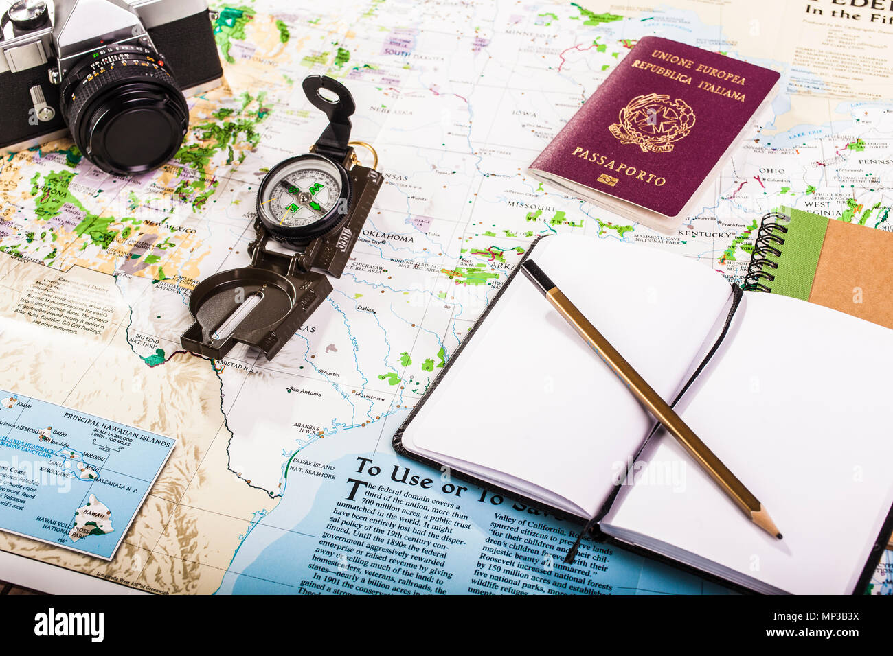 Travel planning. Compass, passport, photo camera and block notes on map ...