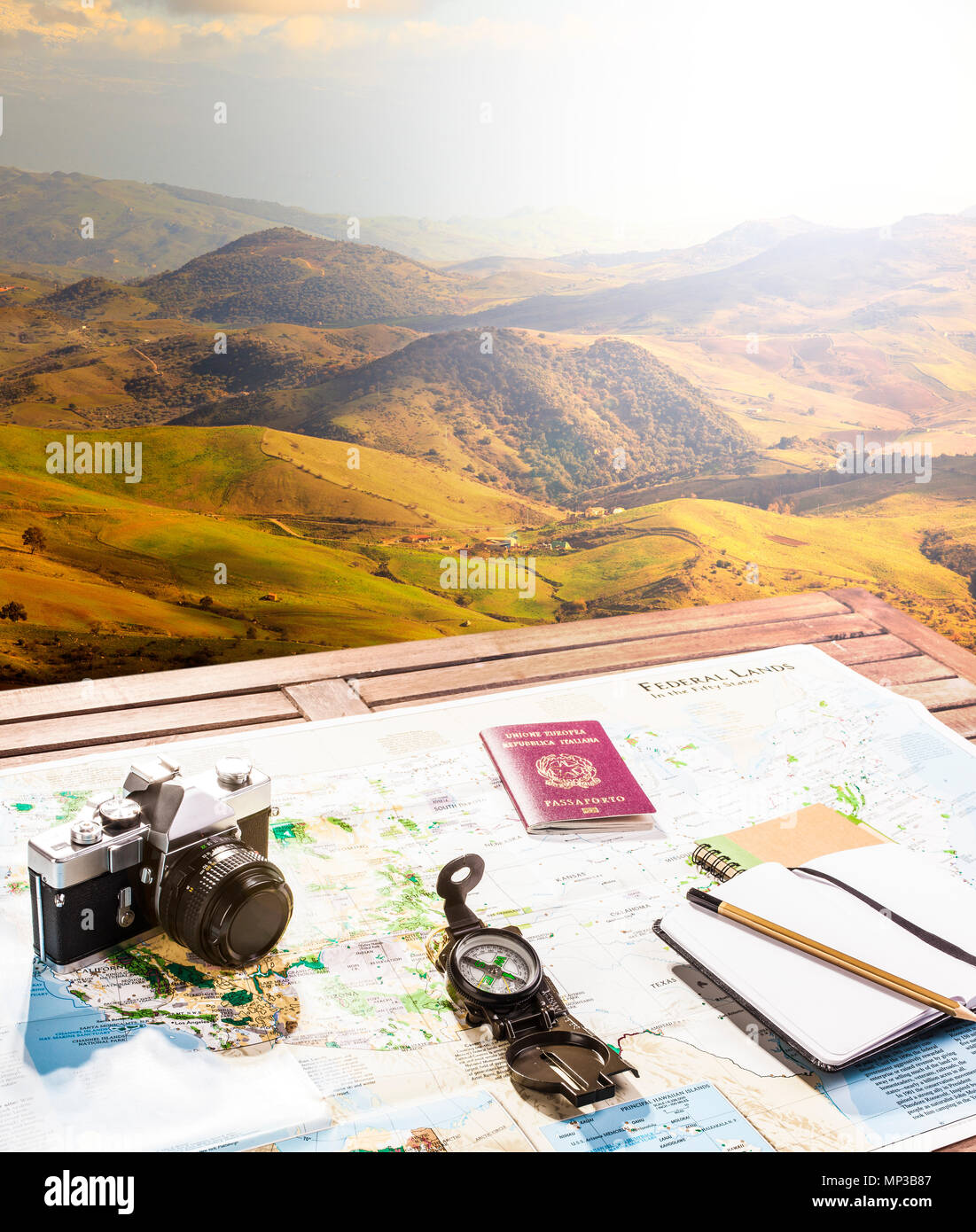 Travel planning. Compass, passport, photo camera and block notes on map ...