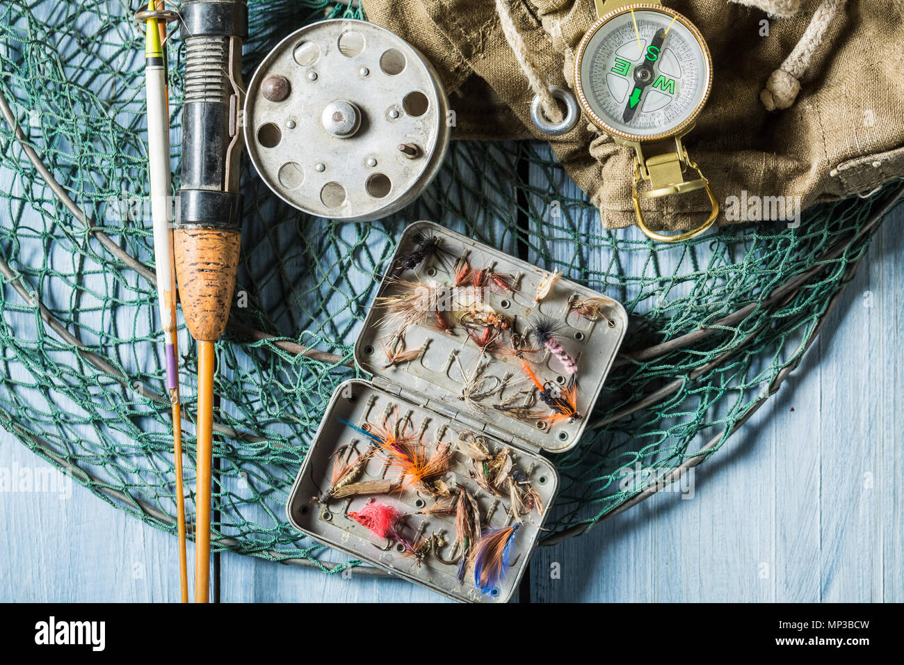 Equipment for fishing with compass, rods and backpack Stock Photo - Alamy