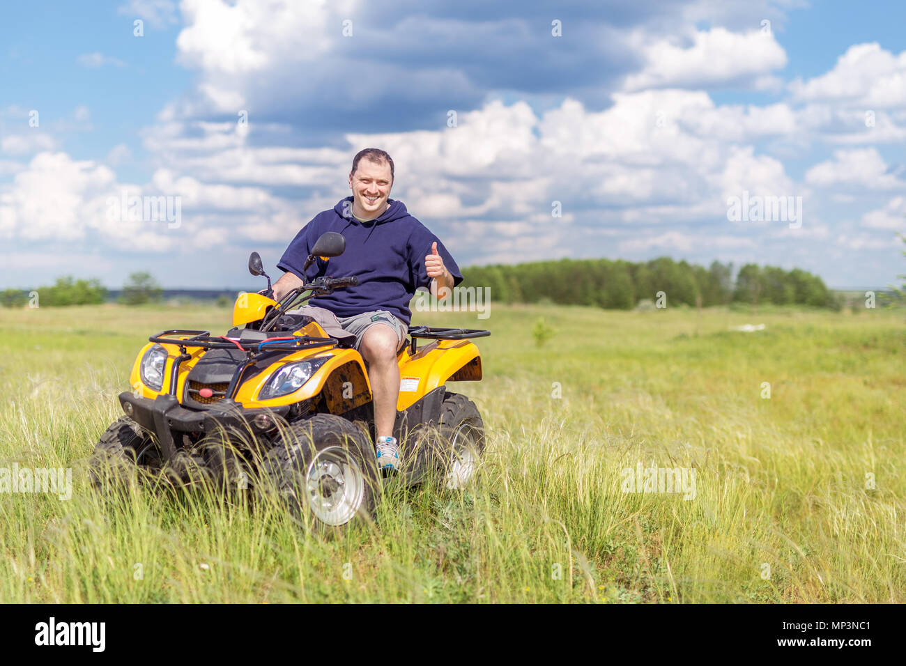 Man riding ATV quad bike at beautiful nature countryside. Driver ...