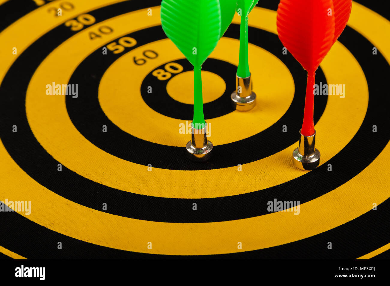 The game of darts, darts on the target Stock Photo - Alamy