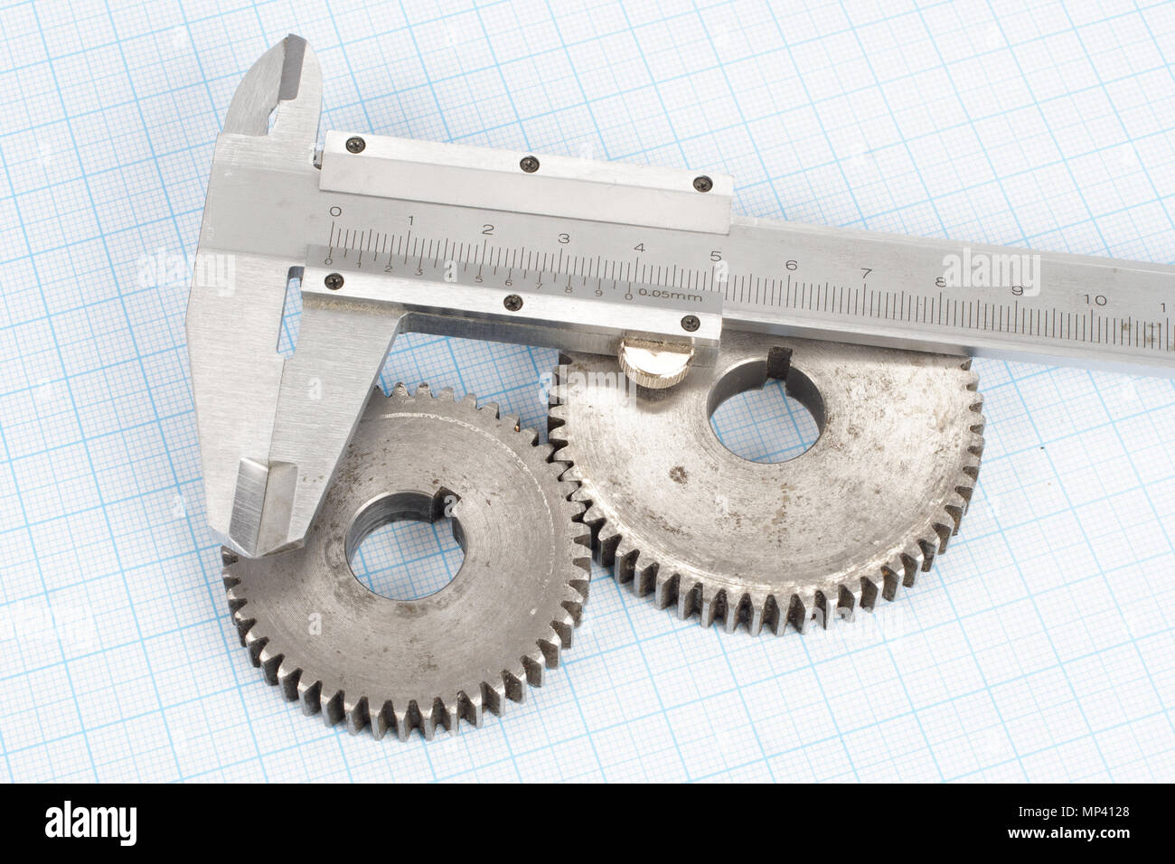 gears and caliper on graph paper background Stock Photo - Alamy