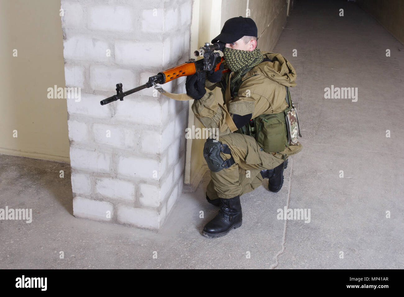 mercenary sniper with sniper rifle inside the building Stock Photo - Alamy