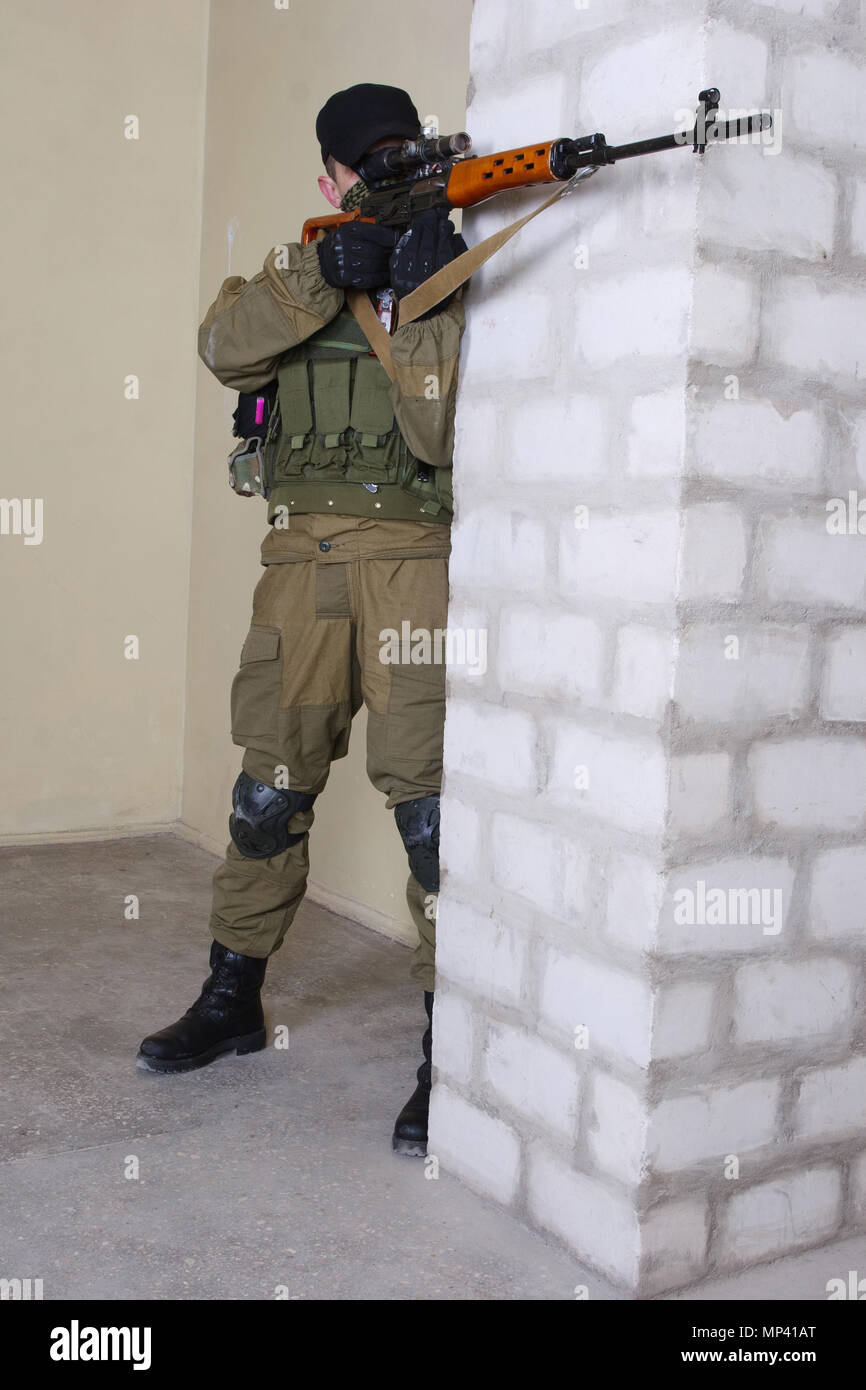 mercenary sniper with sniper rifle inside the building Stock Photo - Alamy