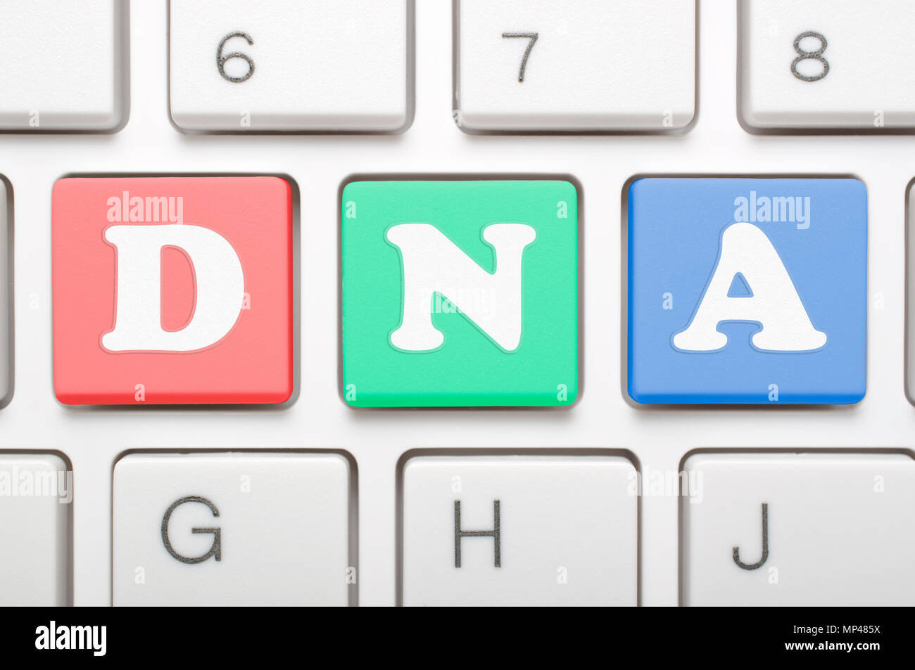 Colorful DNA key on keyboard Stock Photo - Alamy