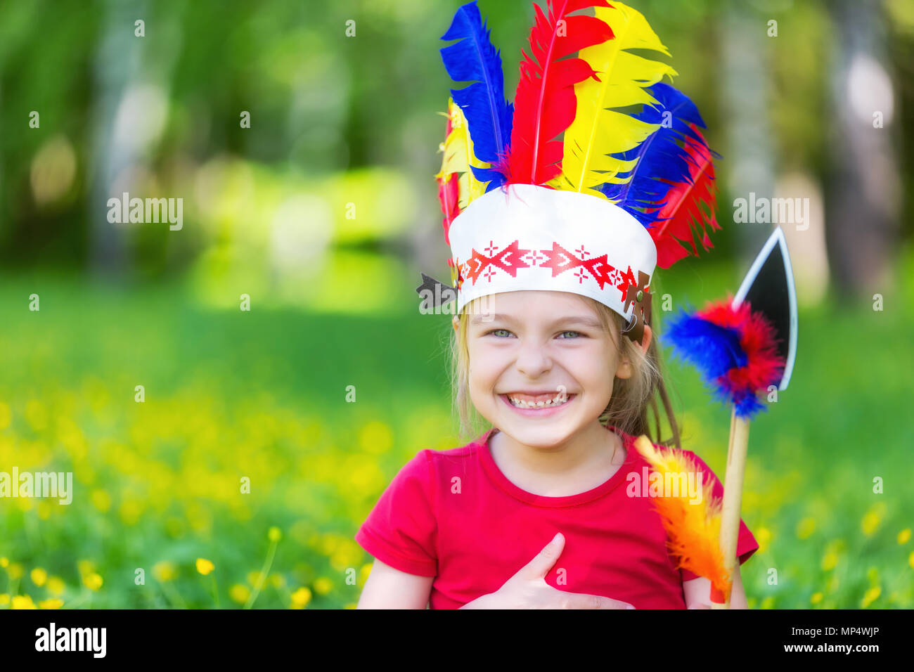 little funny girl playing native american Stock Photo - Alamy